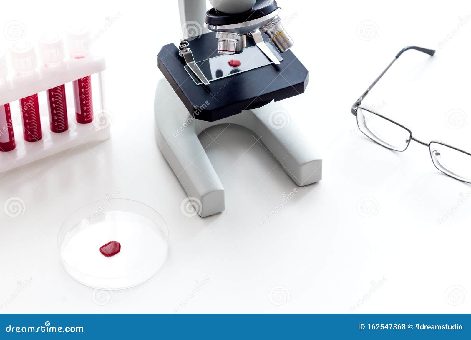Blood Testing Laboratory. Samples Viewing Under Microscope Near Tubes ...