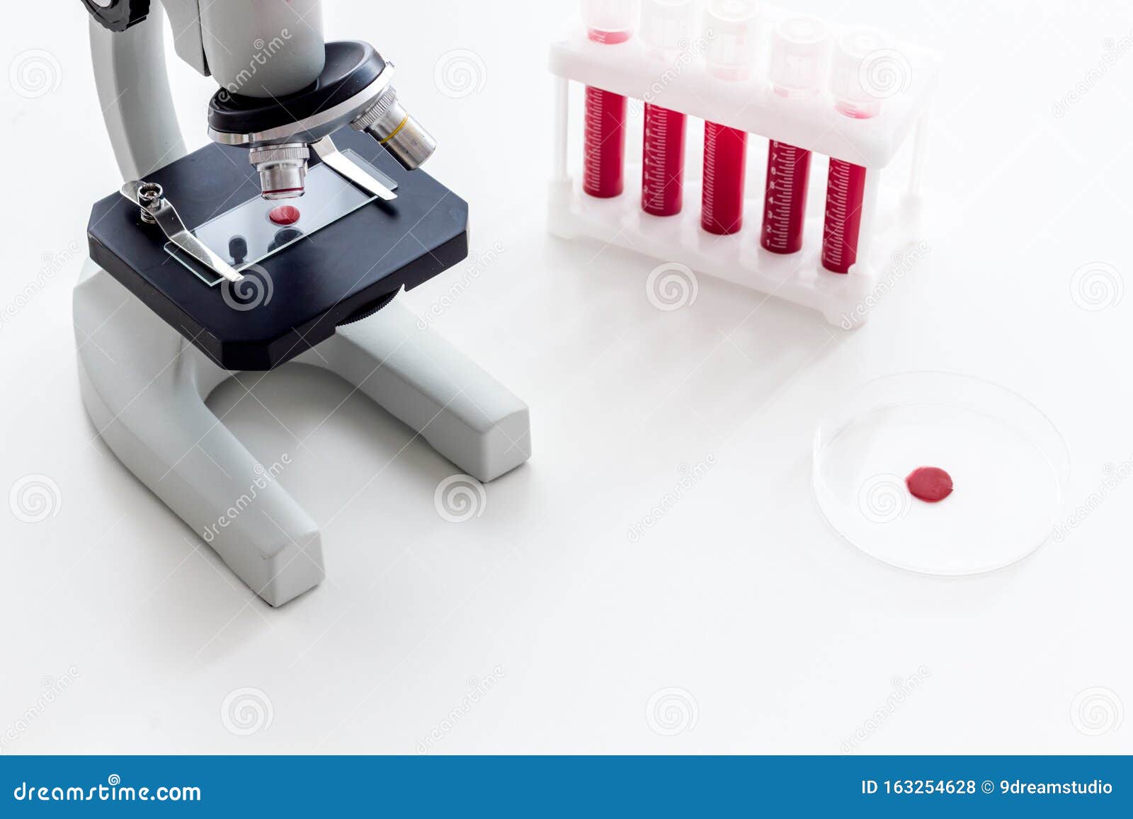 Blood Testing Laboratory. Samples Viewing Under Microscope Near Tubes ...