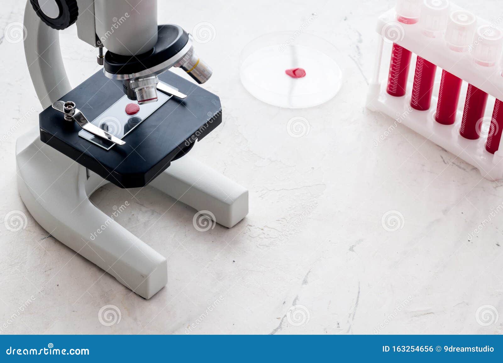 Blood Testing Laboratory. Samples Viewing Under Microscope Near Tubes ...