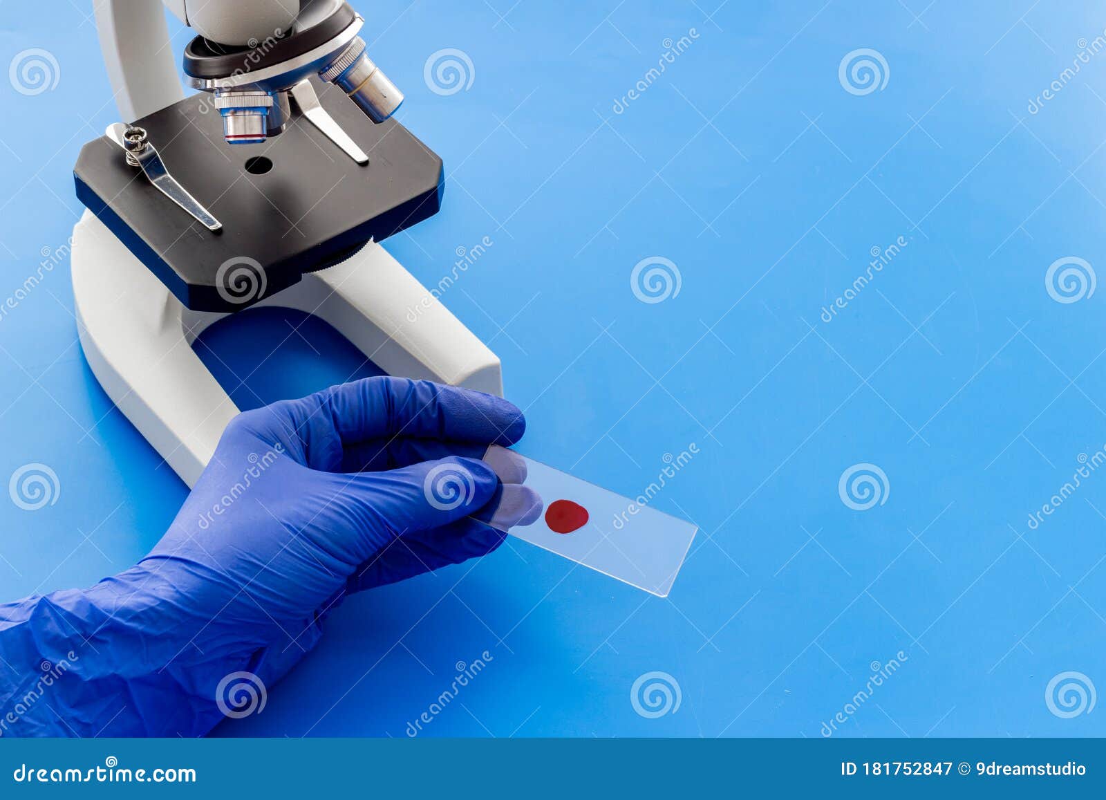 Blood Testing with Microscope in Laboratory. Sample in Hands on Blue ...