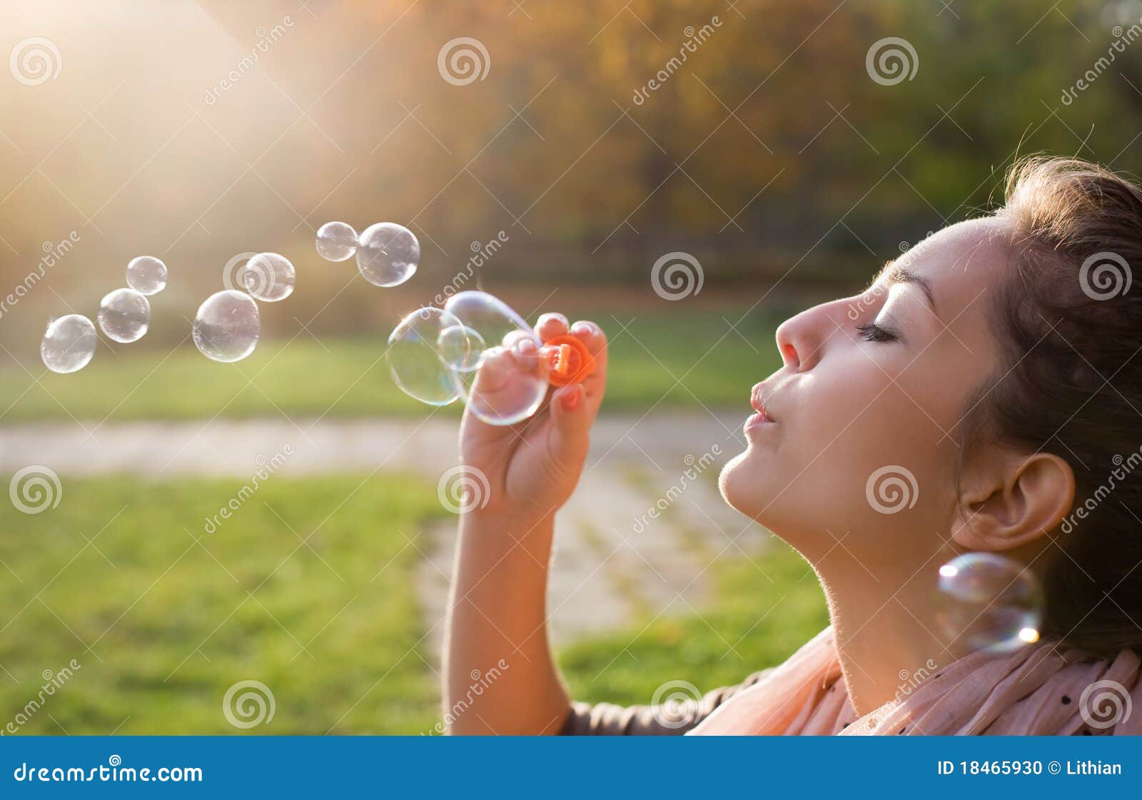 Blowing Bubbles into the Wind. Stock Photo - Image of profile, happy ...