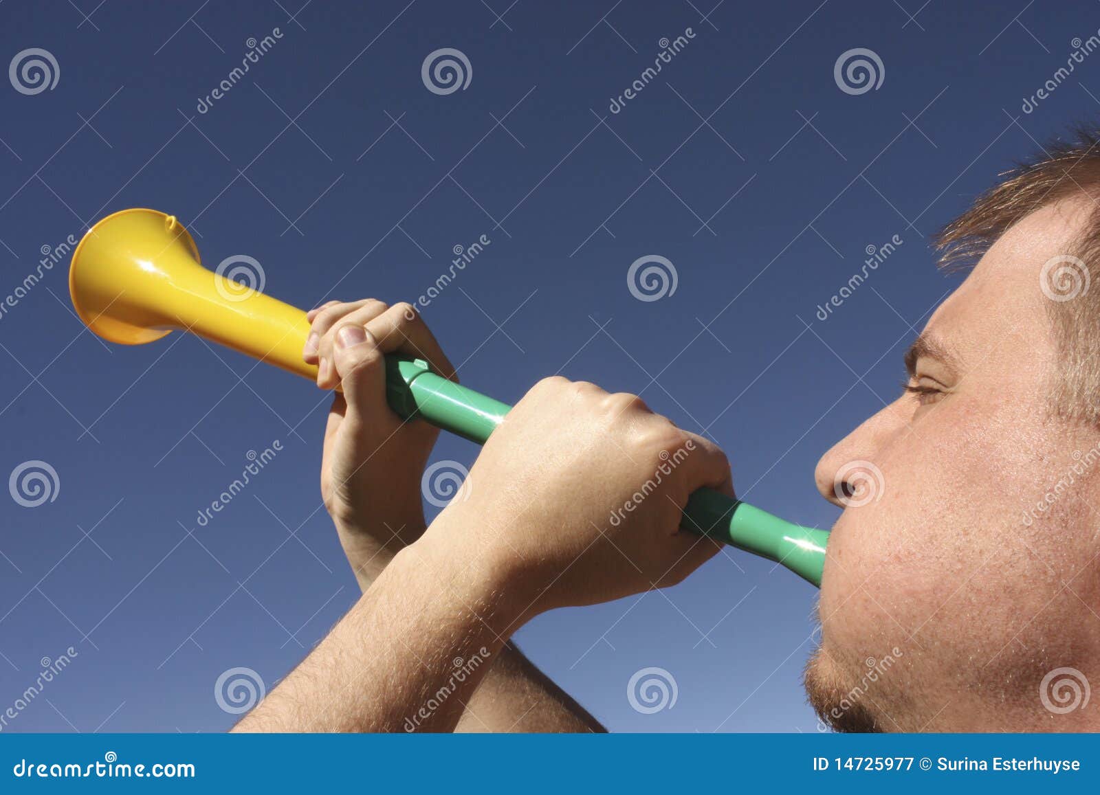 Blowing a vuvuzela stock image. Image of african, yellow - 14725977