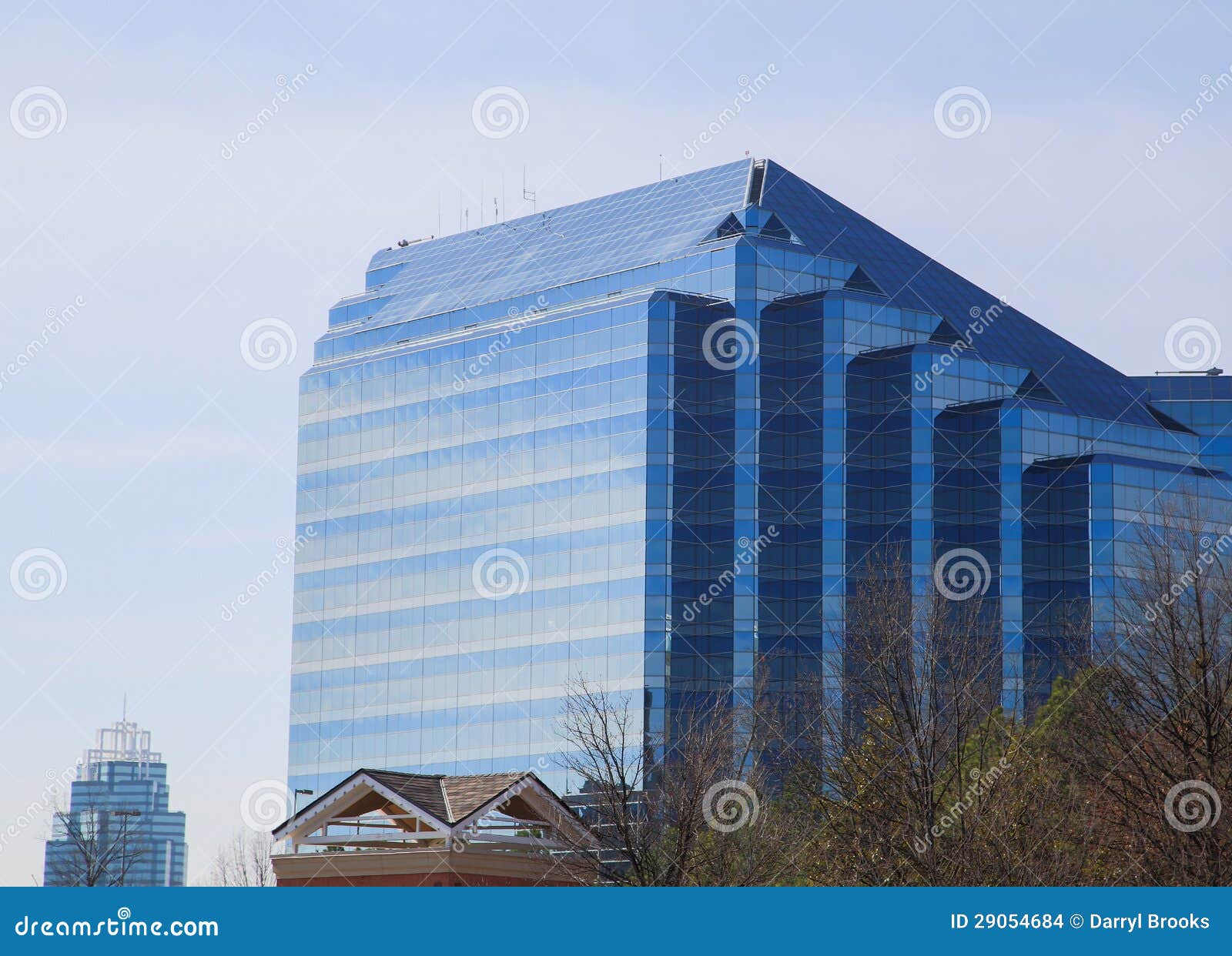 Blue Angled Glass Building Beyond Winter Trees Stock Photo - Image of ...