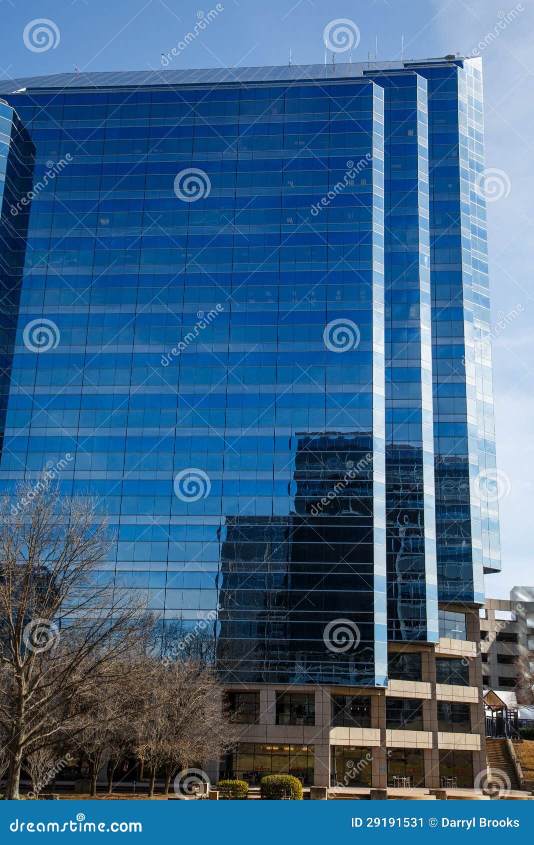 Blue Angled Glass Tower Beyond Landscaping Stock Image - Image of angle ...