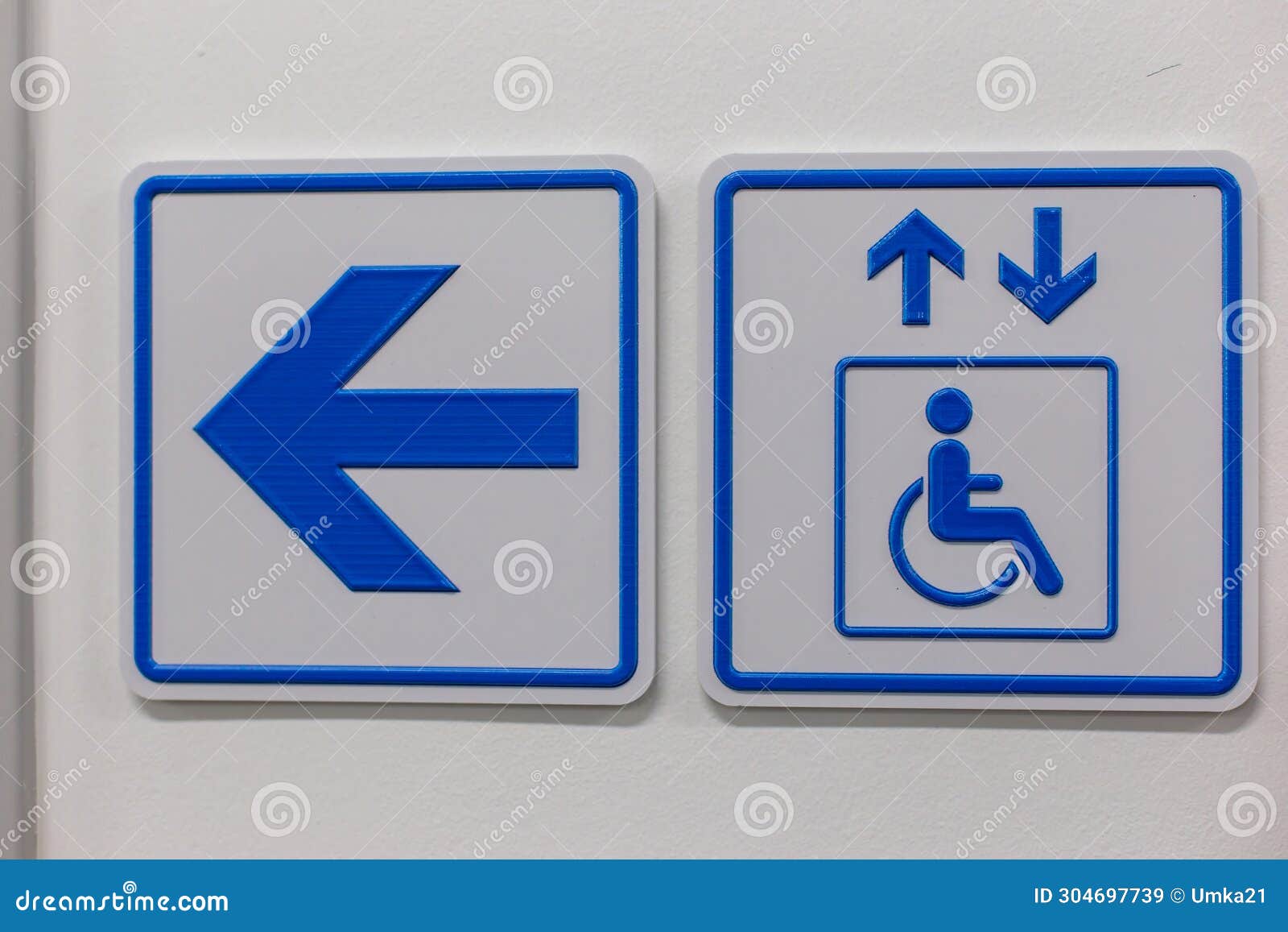 A Blue Arrow and Elevator Access Signs Disabled Person on the Wall ...