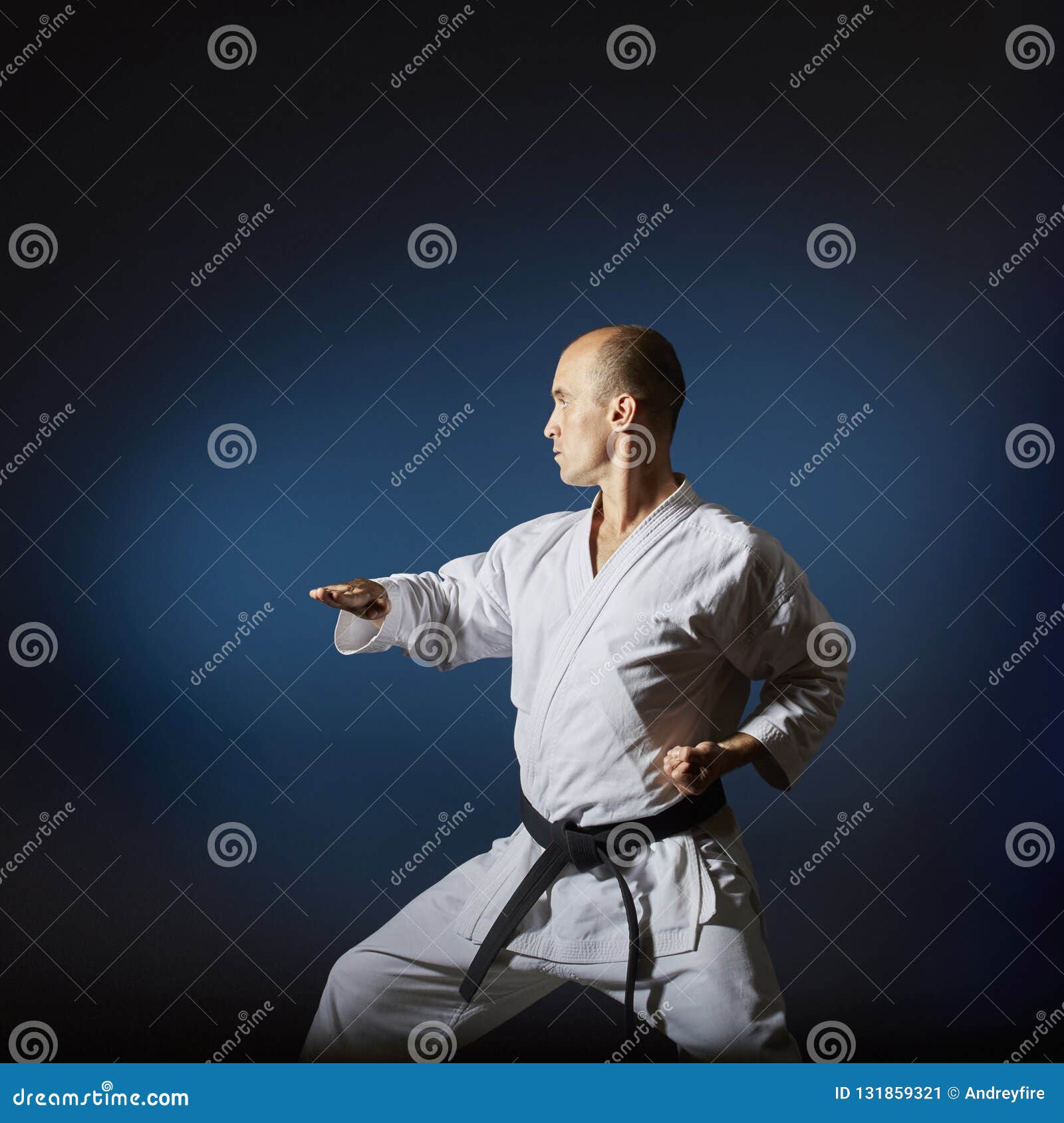 On a Blue Background with a Gradient, an Athlete with a Black Belt ...
