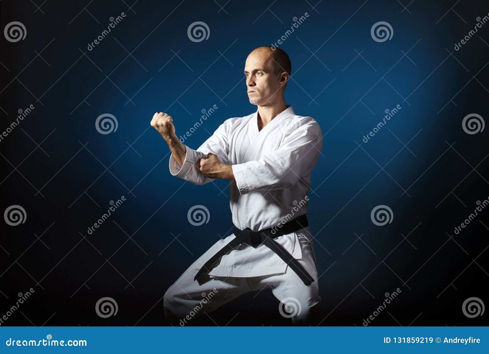 On a Blue Background with a Gradient the Athlete Doing Formal Karate ...