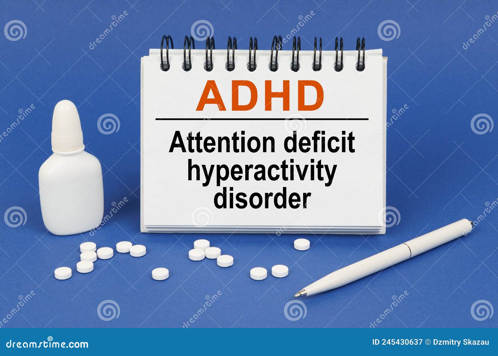 On a Blue Background, a Pen, Tablets and a Notepad with the Inscription ...