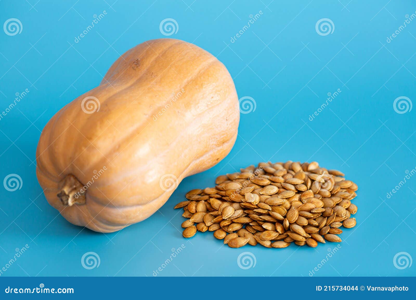 On a Blue Background, Pumpkin and Heap of Fried Seeds. Stock Photo ...