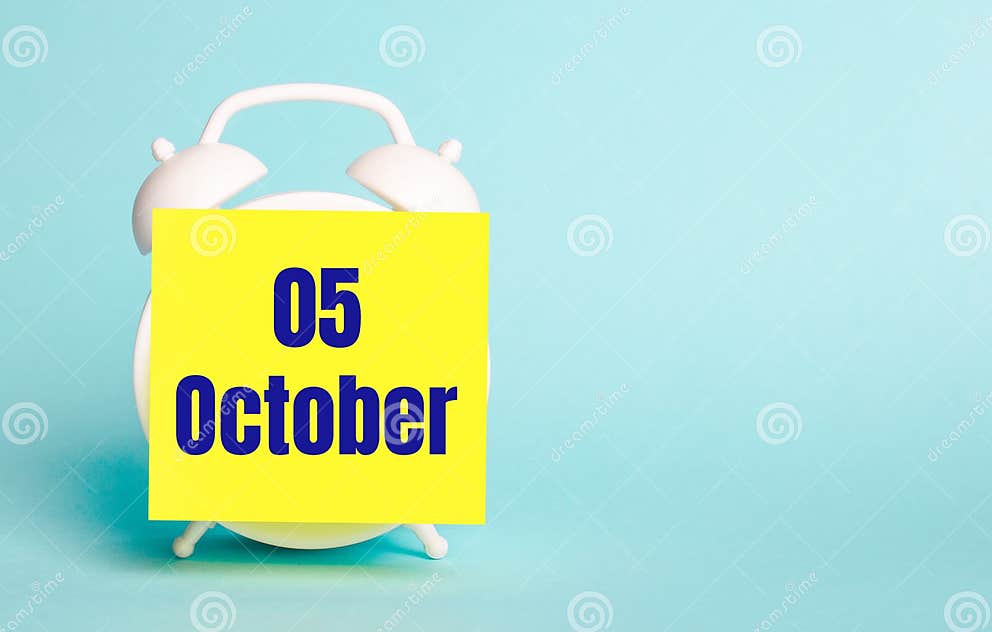 On a Blue Background - a White Alarm Clock with a Yellow Sticker for ...