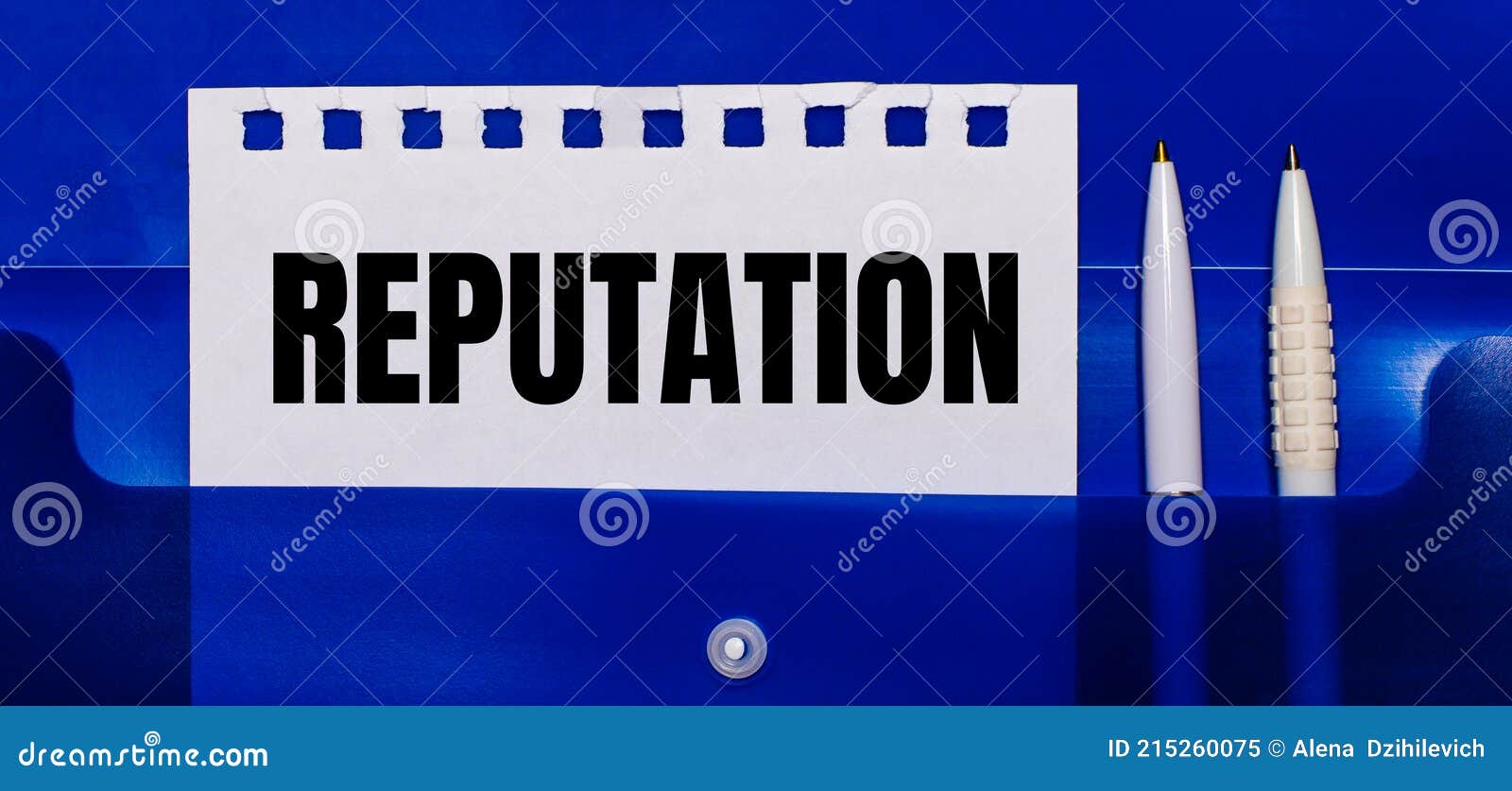 On a Blue Background, White Pens and a Sheet of Paper with the Text ...