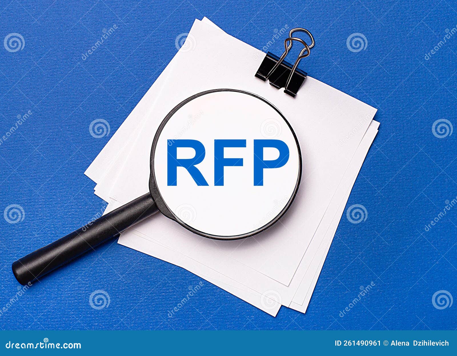 On a Blue Background, White Sheets Under a Black Paper Clip and on Them ...