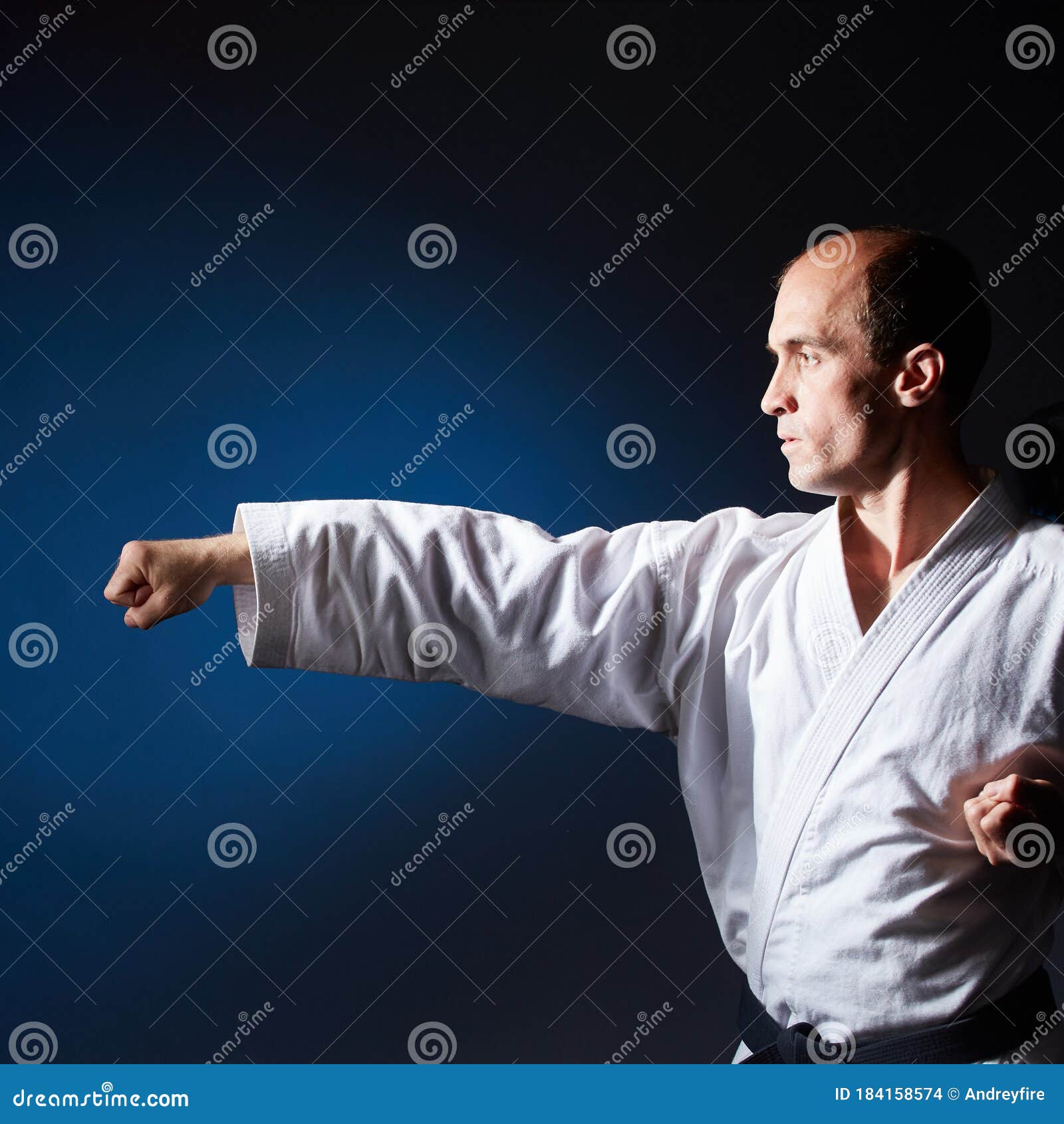 On a Blue Background a Young Athlete Makes a Punch Arms Stock Photo ...