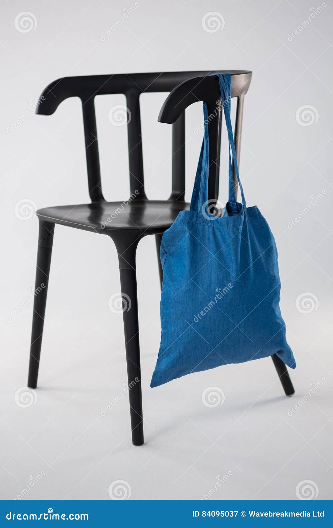 Blue Bag Hanging on a Black Chair Stock Image - Image of blue ...