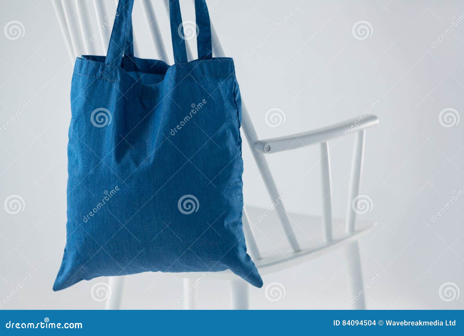 Blue Bag Hanging on a White Chair Stock Photo - Image of conservation ...