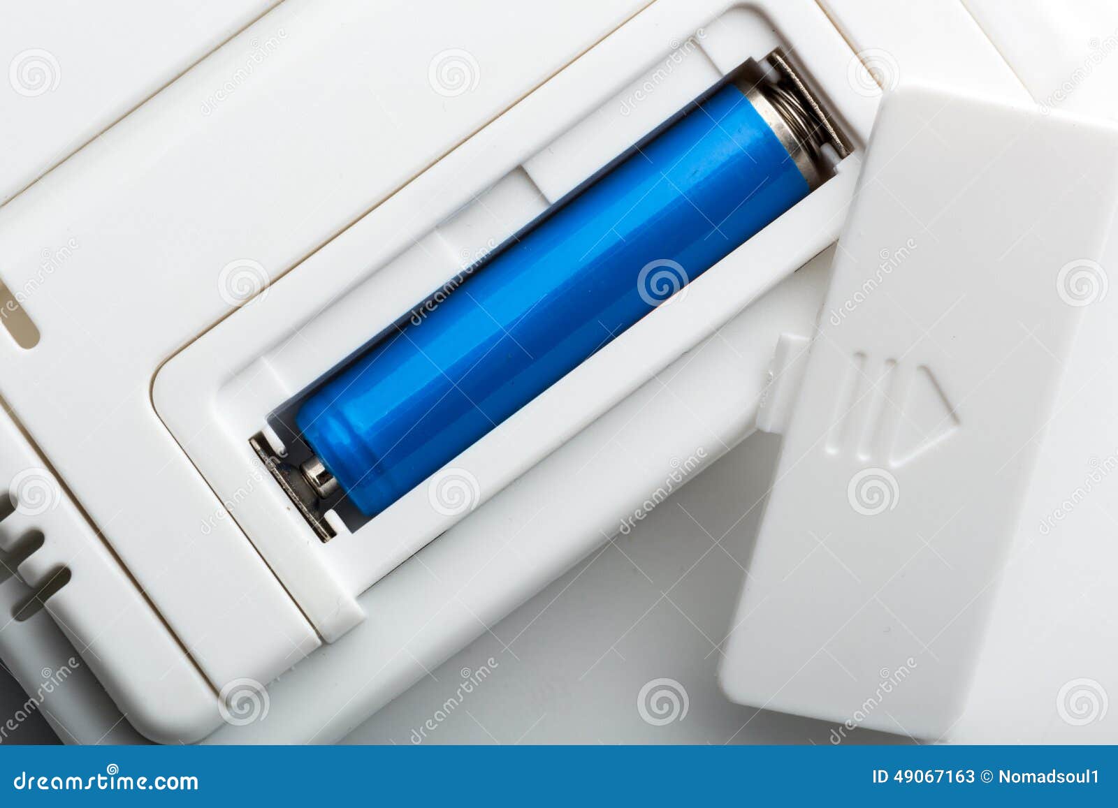Blue battery in the socket stock image. Image of rear - 49067163