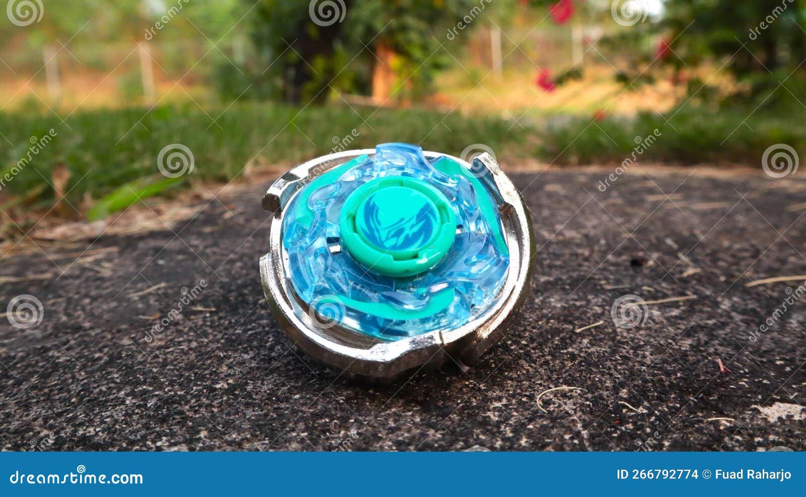 Blue Beyblade is on the Rock Stock Photo - Image of circle, lawn: 266792774