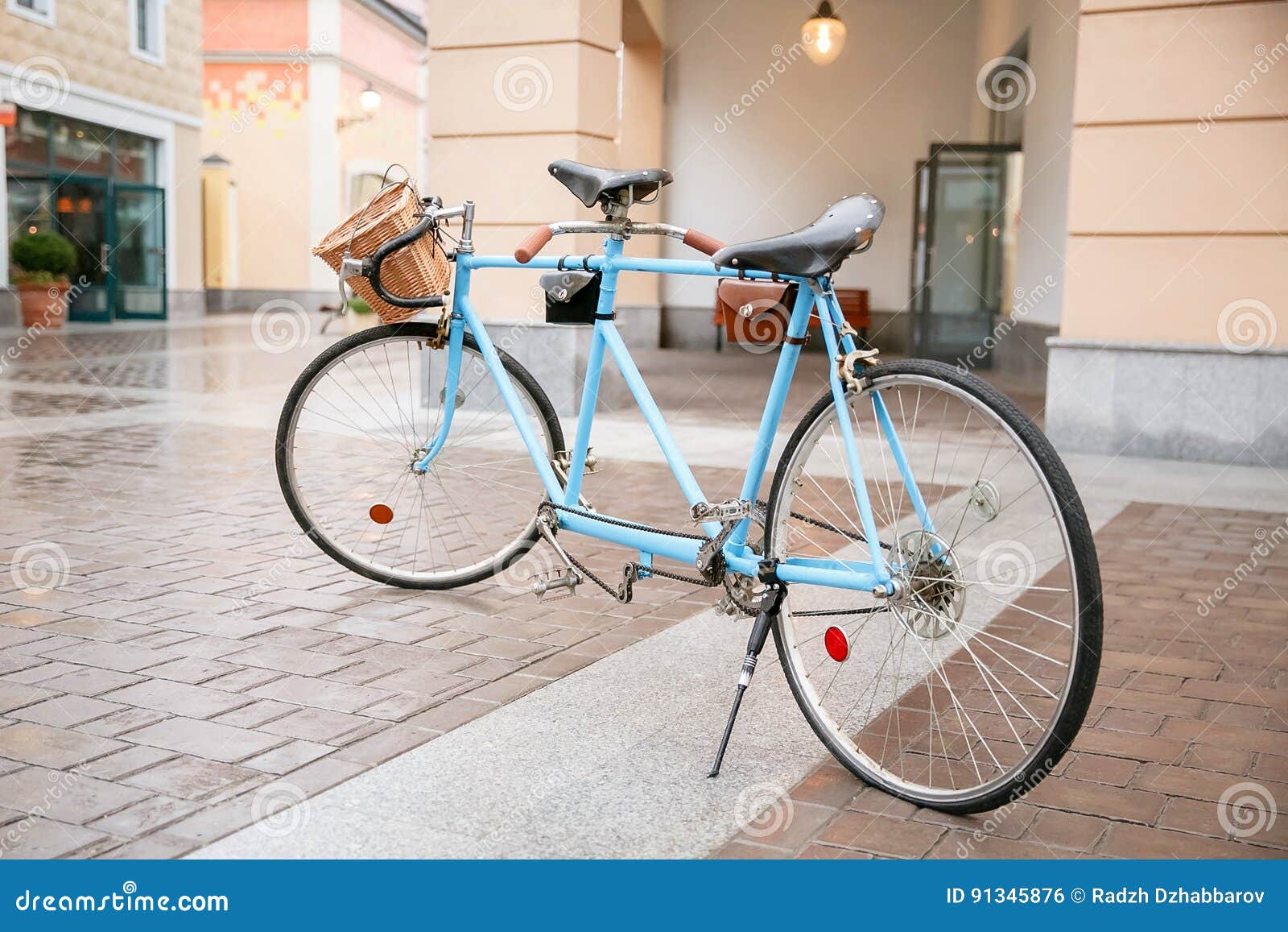 Blue Bicycle on Street in Background of Shops Stock Photo - Image of ...