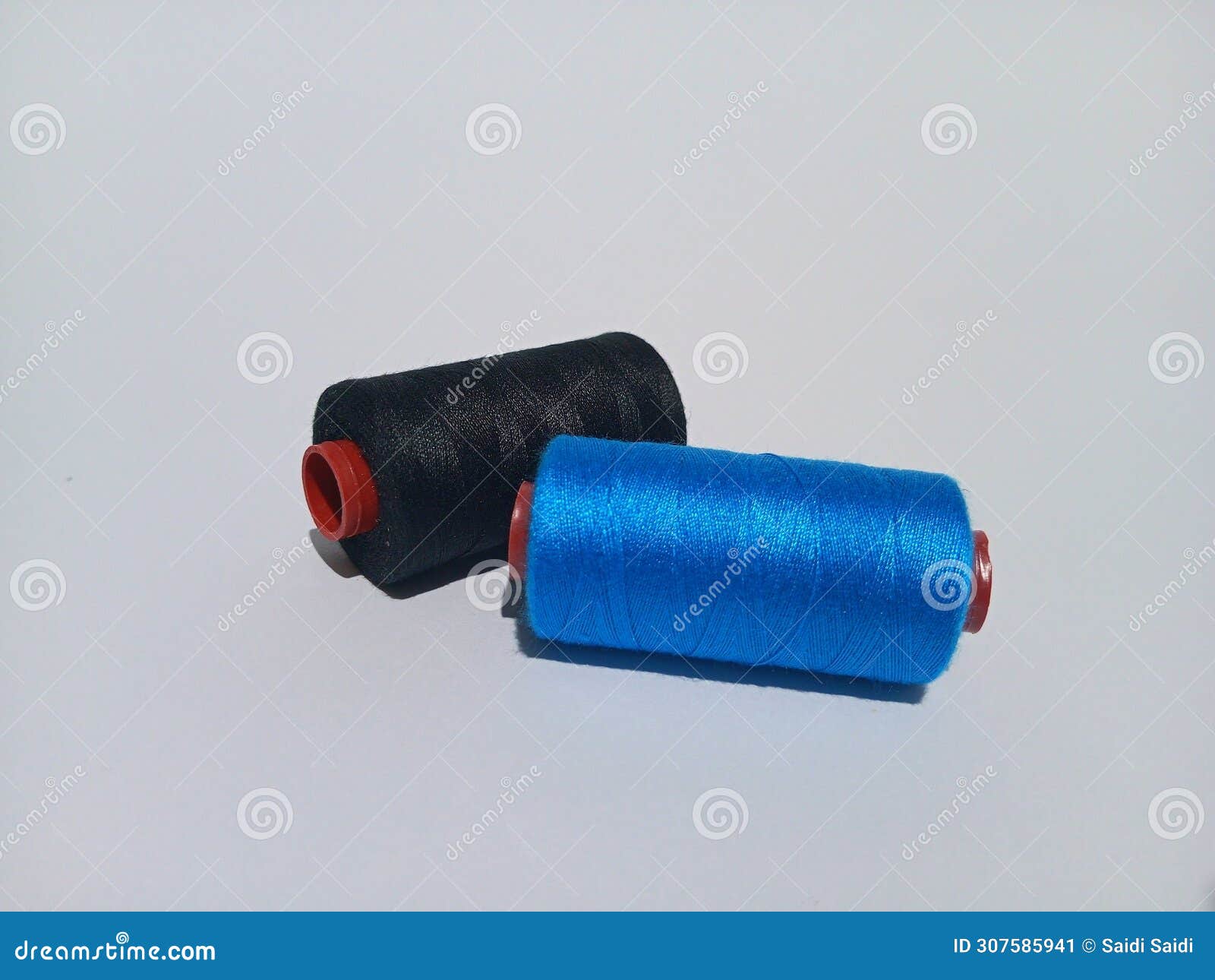 Blue and Black Sewing Thread on White Background Stock Image - Image of ...