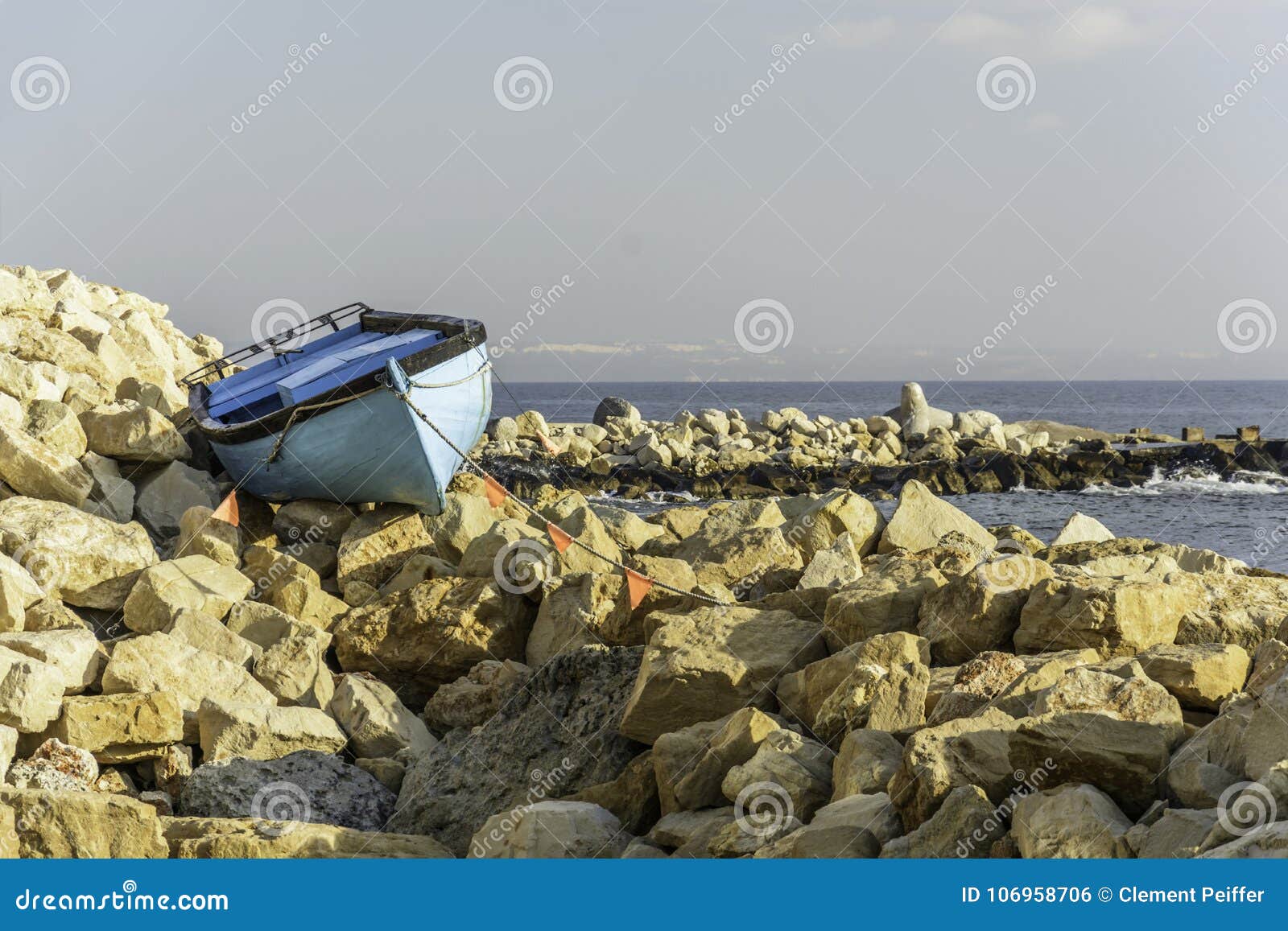 Litle boat on the rocks stock photo. Image of broken - 106958706