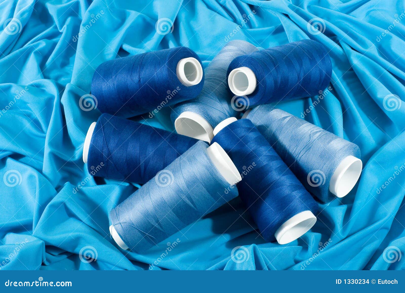 Blue Bobbins of Threads on Blue Cloth Stock Photo - Image of conical ...