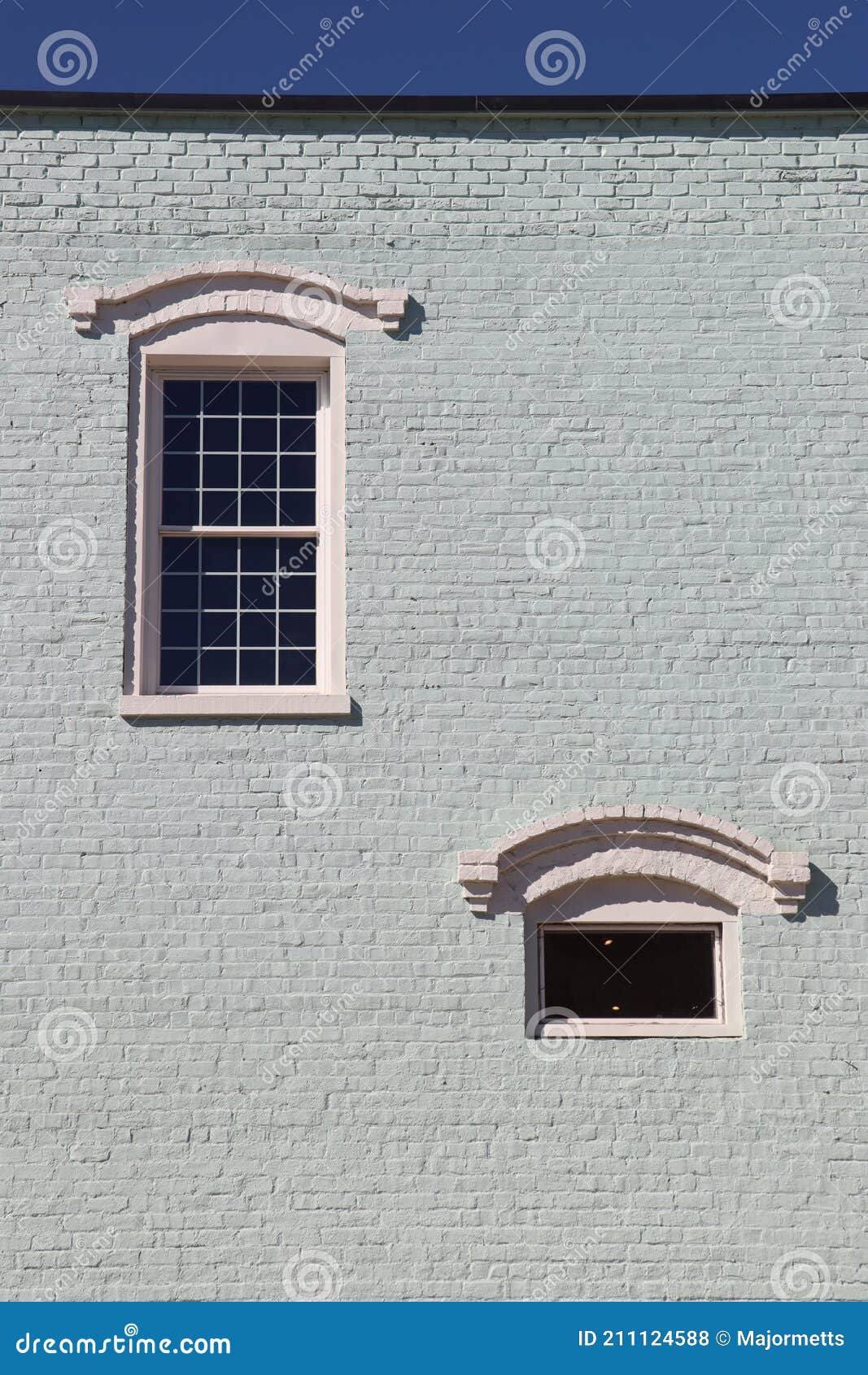 Blue Brick Building Side with White Arched Windows Stock Photo - Image ...