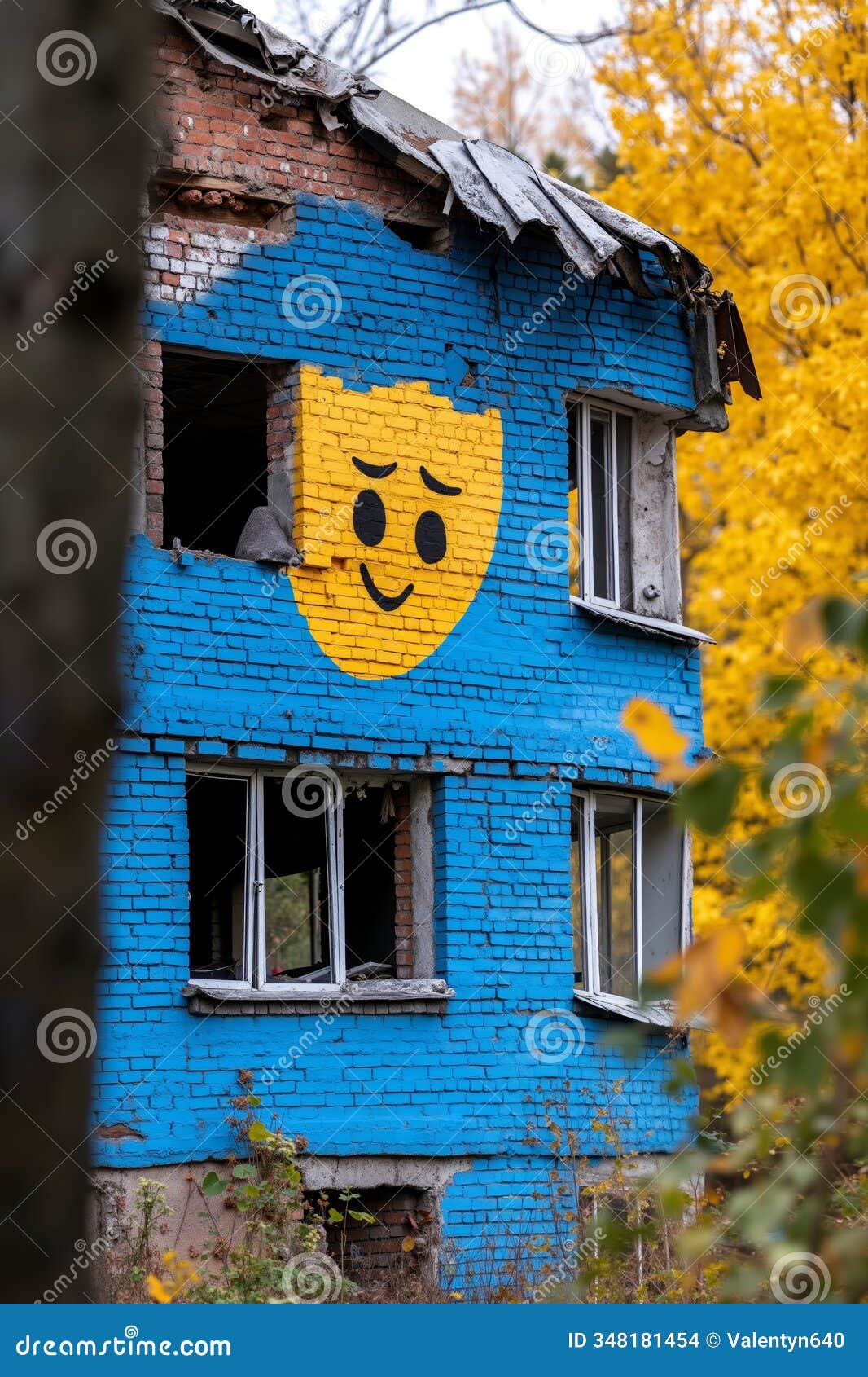 A Blue Building with a Smiley Face Painted on the Side of it Stock ...