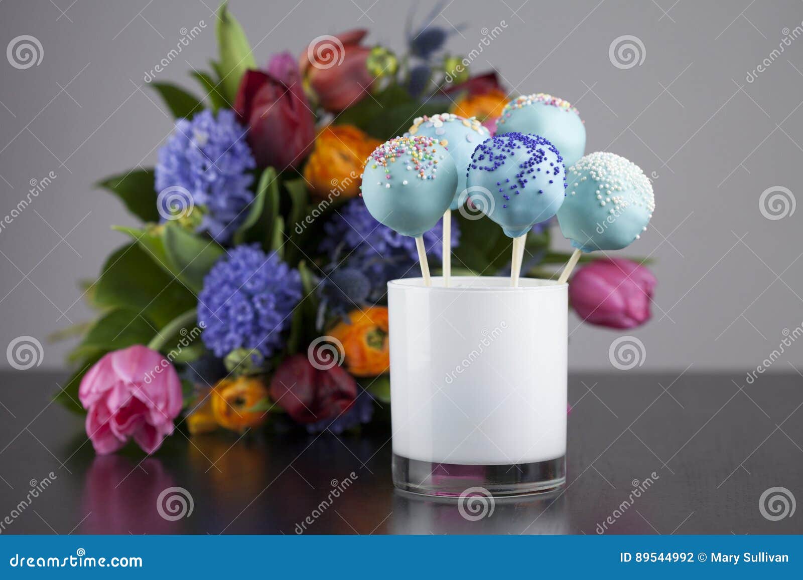 Blue Cake Pops with Colorful Sprinkles with Beautiful Flowers Stock ...