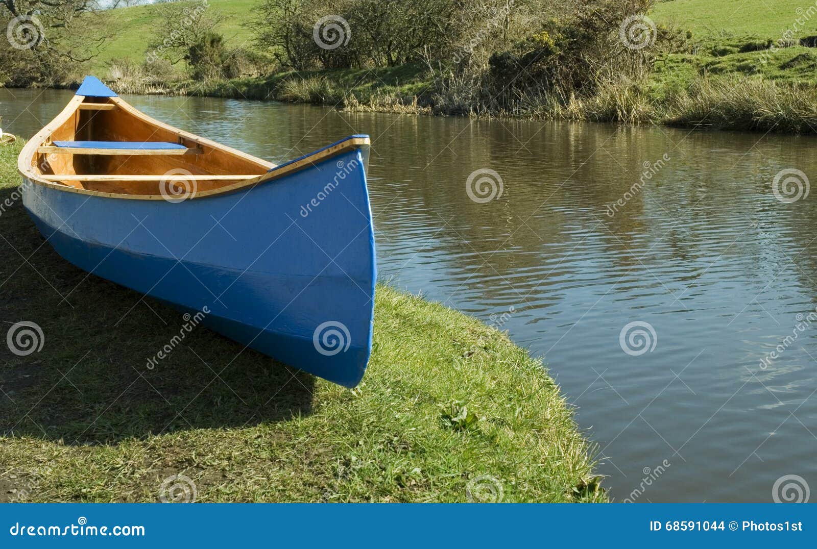 Blue Canoe With Floating Paddles In The Emerald Lake With Islands And ...