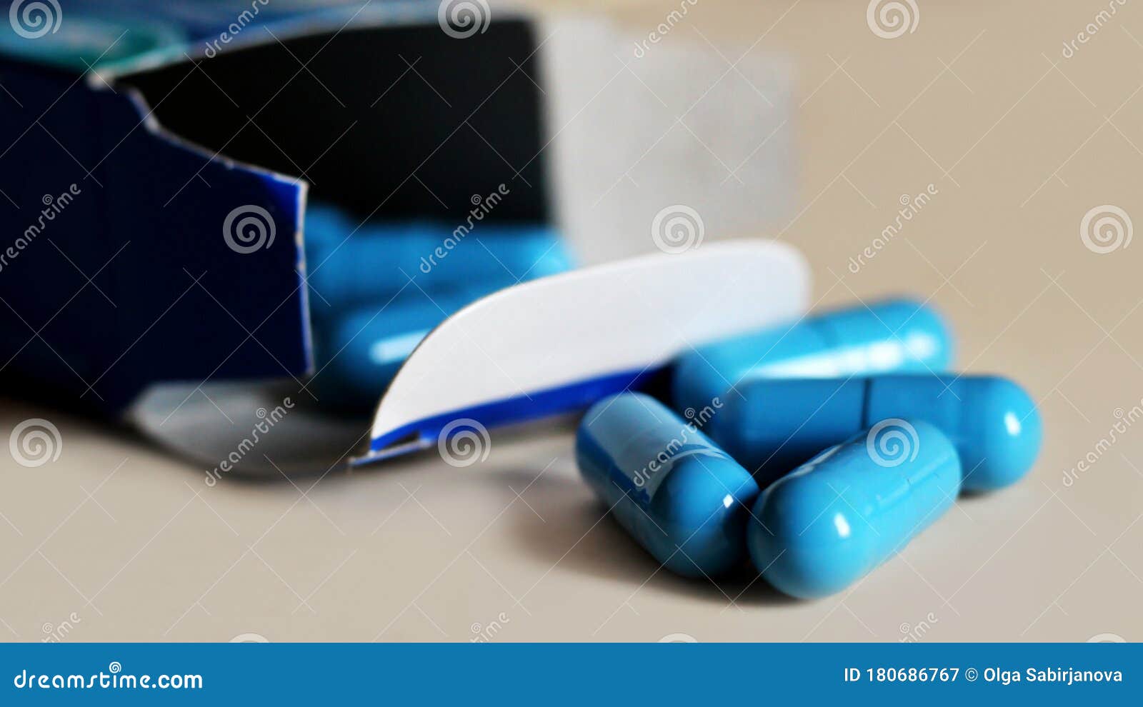 Blue Capsules and a Box of Medication Stock Image - Image of capsules ...