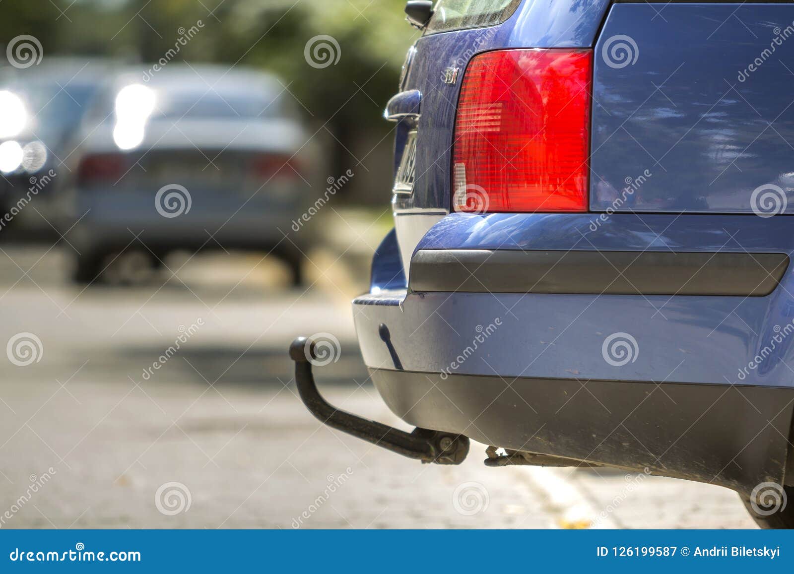 Blue Car Parked on Sunny Street, Red Stop Lights, Hook for Dragging ... Blue Car Parked on Sunny Street, Red Stop Lights, Hook for Dragging ...