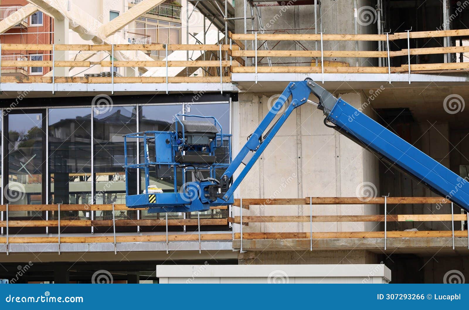 Blue Cherry Picker at Work on the Facade of a New Building Under ...
