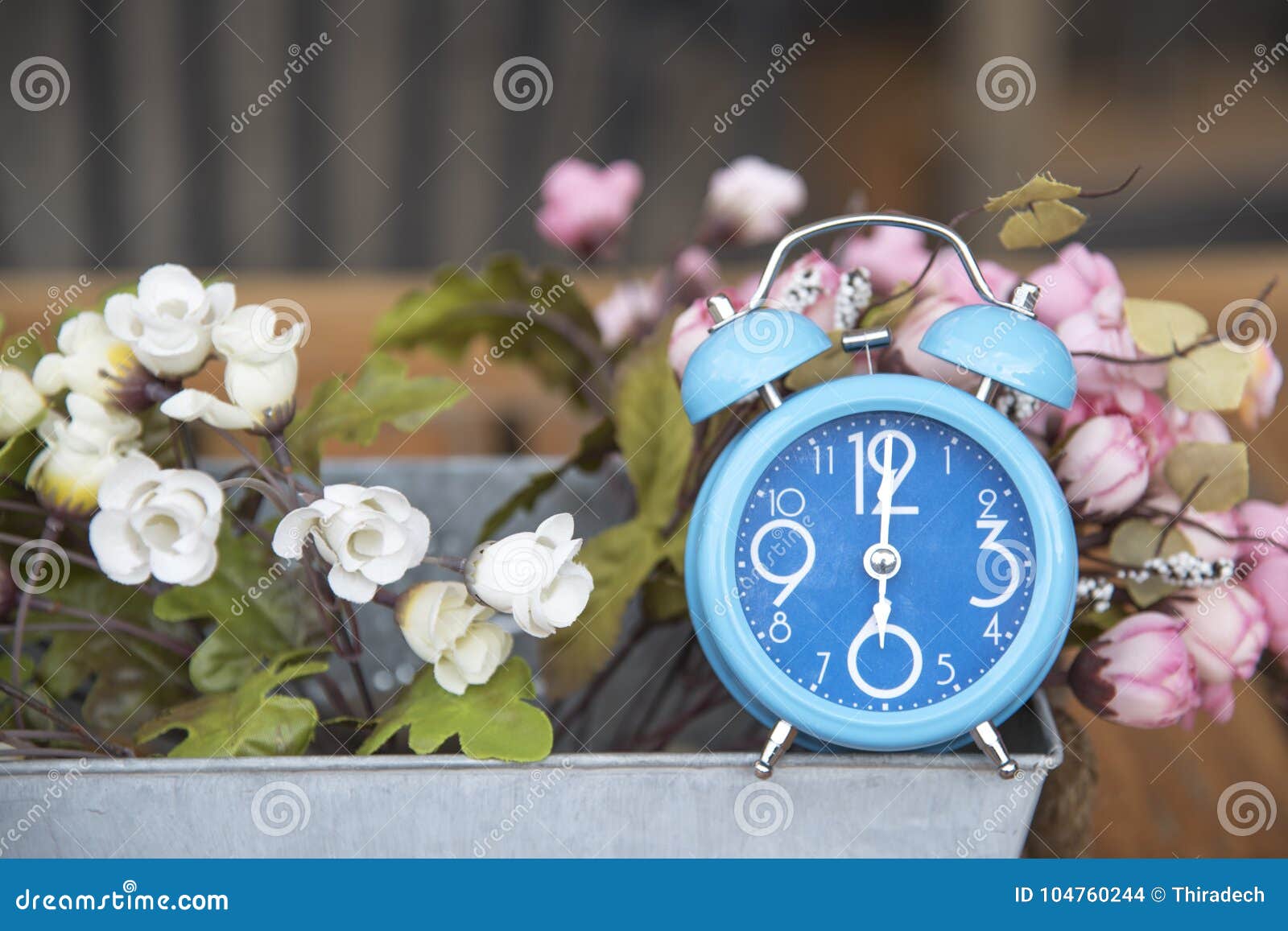 Blue Clock with Artificial Flowers Stock Photo - Image of white, nature ...