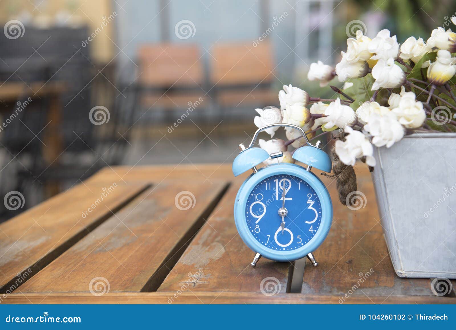 Blue Clock with Artificial Flowers Stock Photo - Image of alarm, time ...
