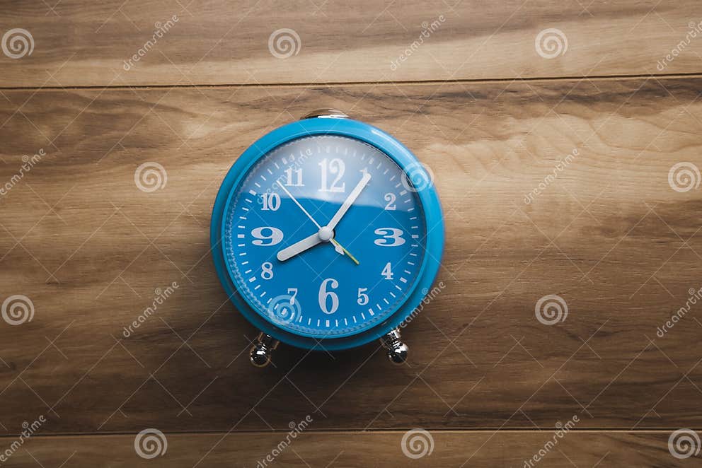 Blue Clock on the Wooden Table Stock Image - Image of white, classic ...