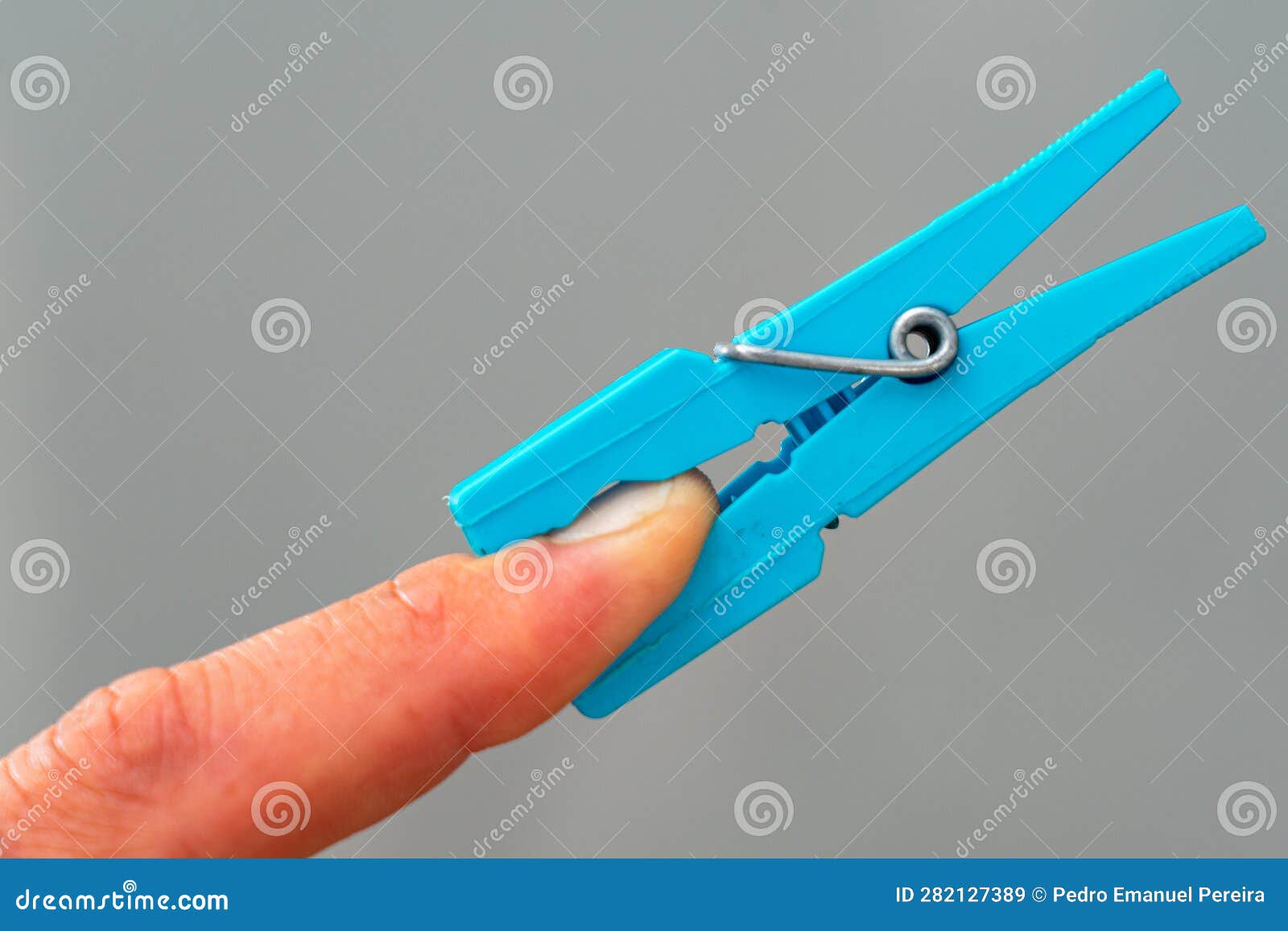 Blue Clothes Peg Pinching Index Finger Stock Image - Image of blue ...