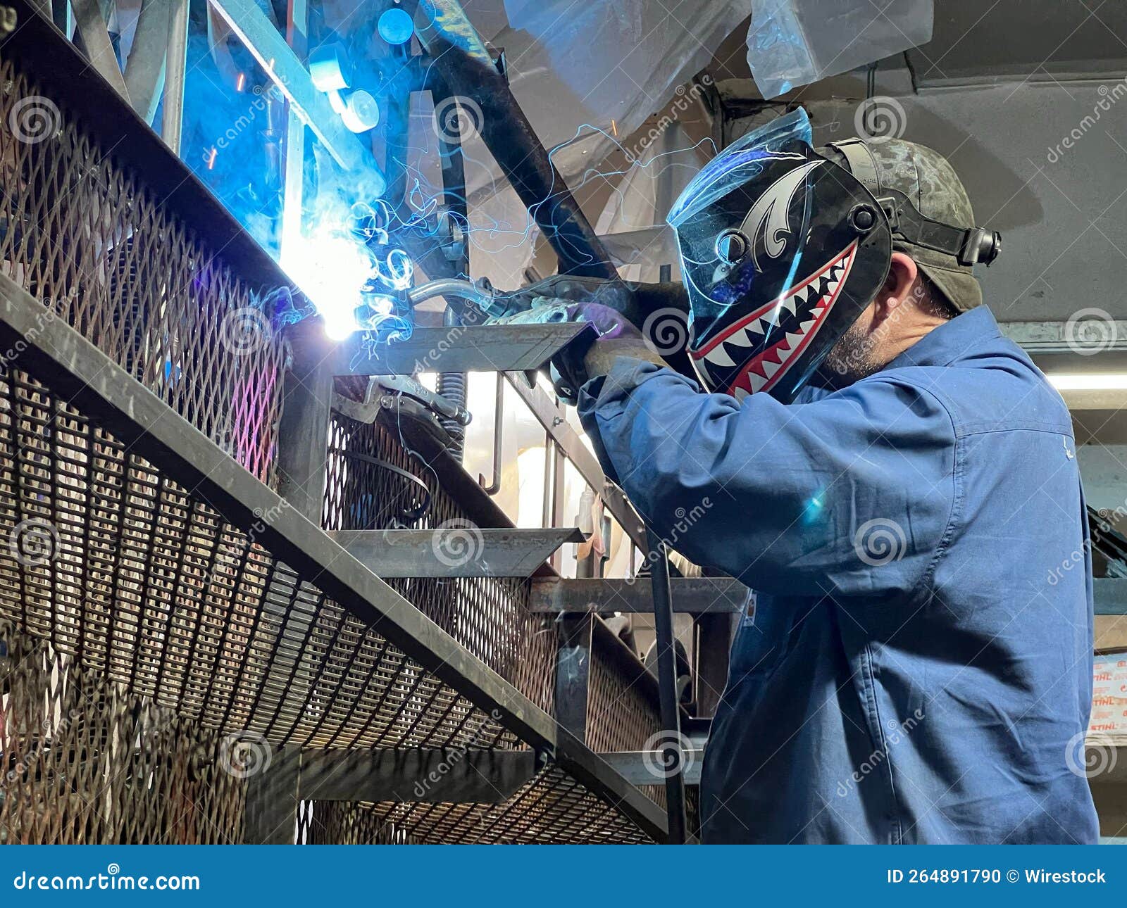 Blue Collar Worker in a Mask Welding during Building Construction Stock ...