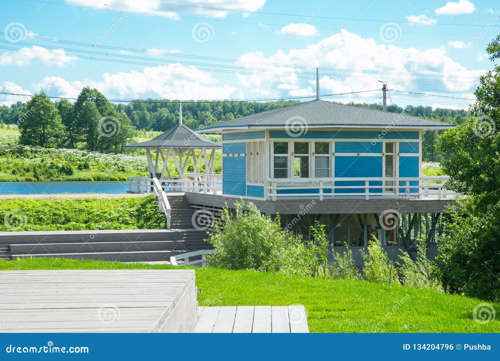 Blue Colored Cottage on the Lake Stock Photo - Image of forest, painted ...