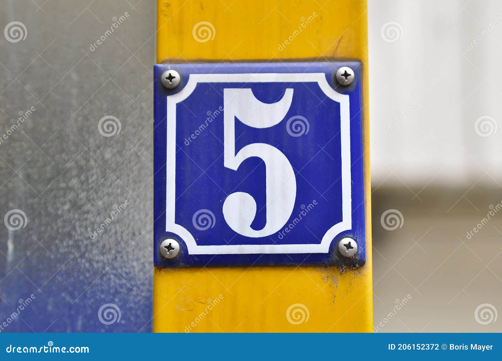 A Blue Colored House Number Plaque on a Yellow Background, Showing the ...