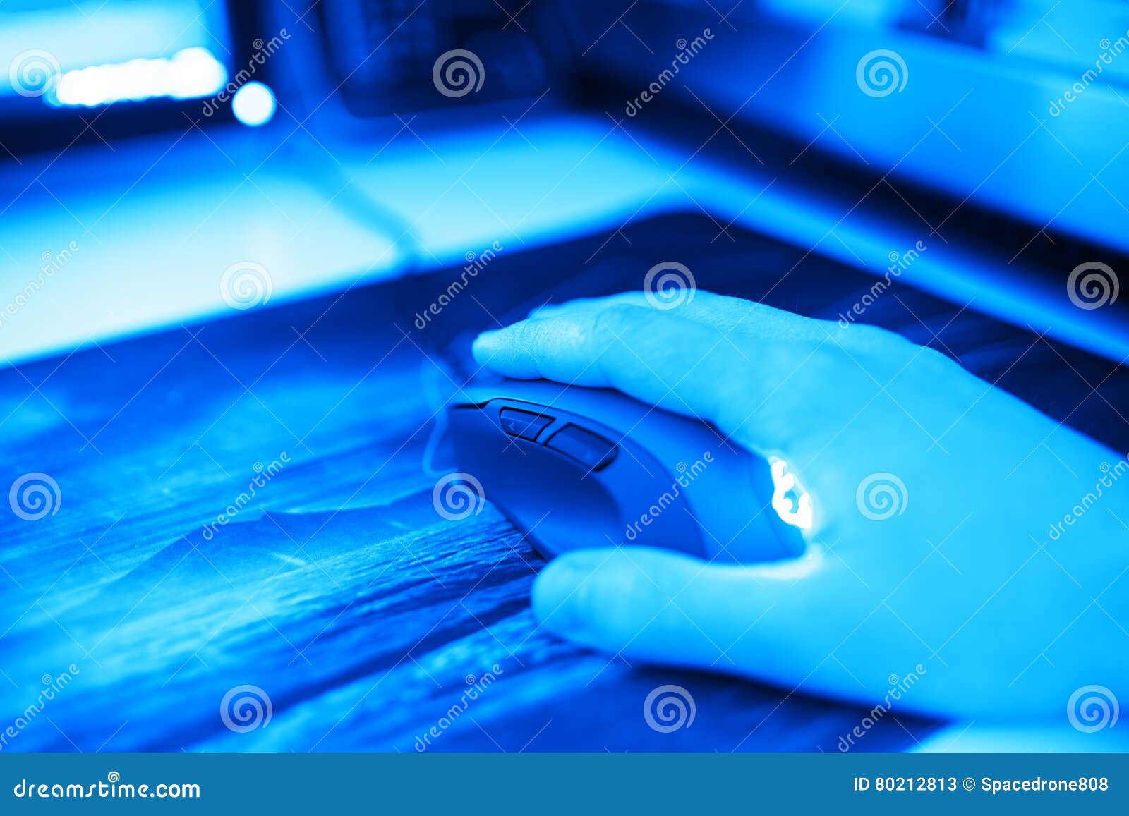 Blue Computer Mouse with Human Hand on Mousepad Bokeh Backdrop Stock ...
