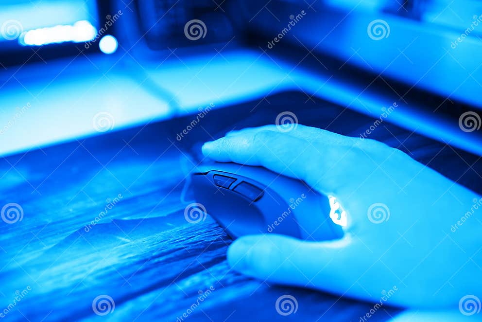 Blue Computer Mouse with Human Hand on Mousepad Bokeh Backdrop Stock ...