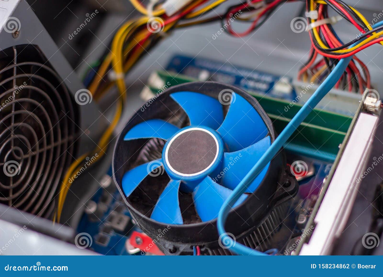 Blue Cooler Fan with Motherboard Inside a Computer. Stock Photo - Image ...