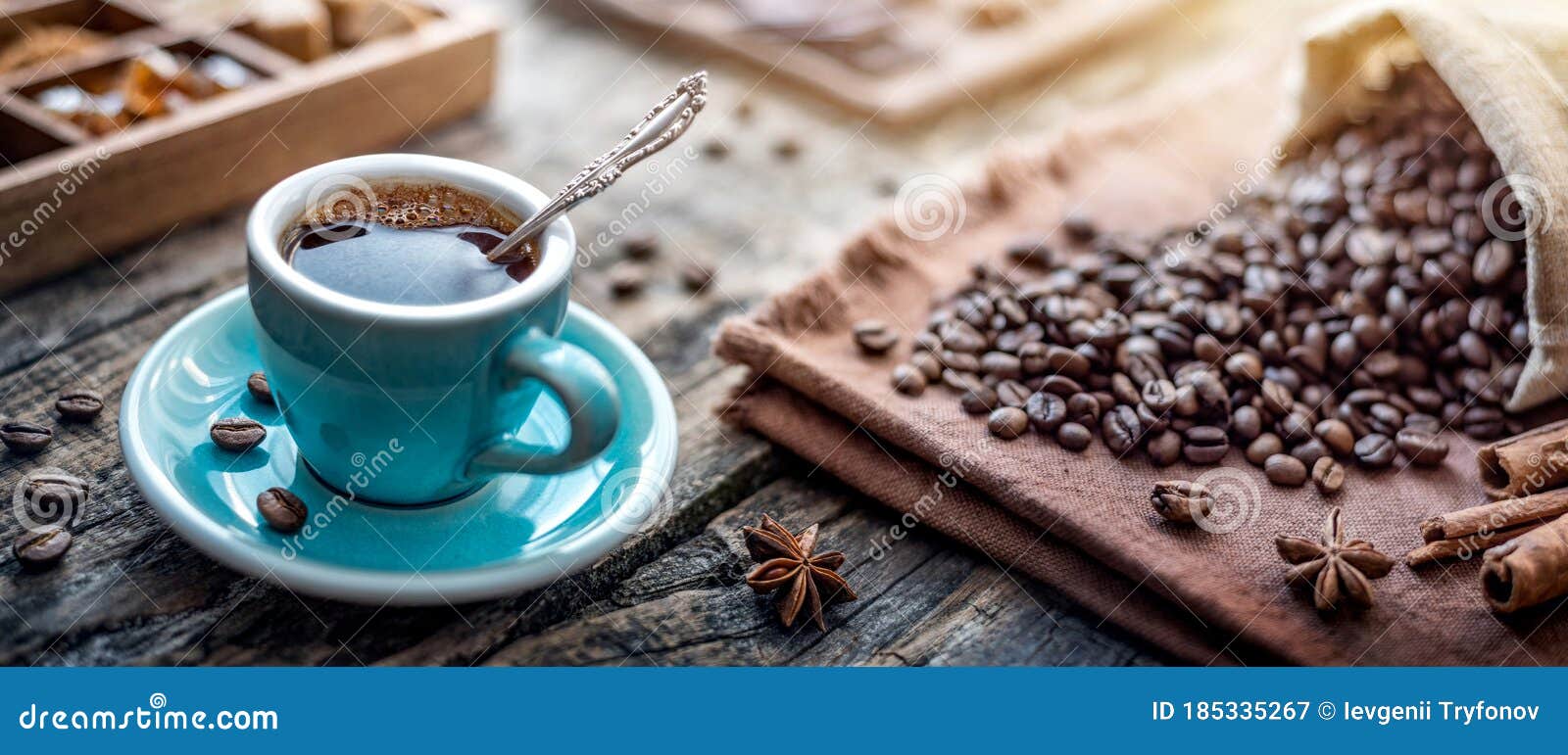 A Blue Cup of Aromatic Black Coffee and Coffee Beans on the Table ...