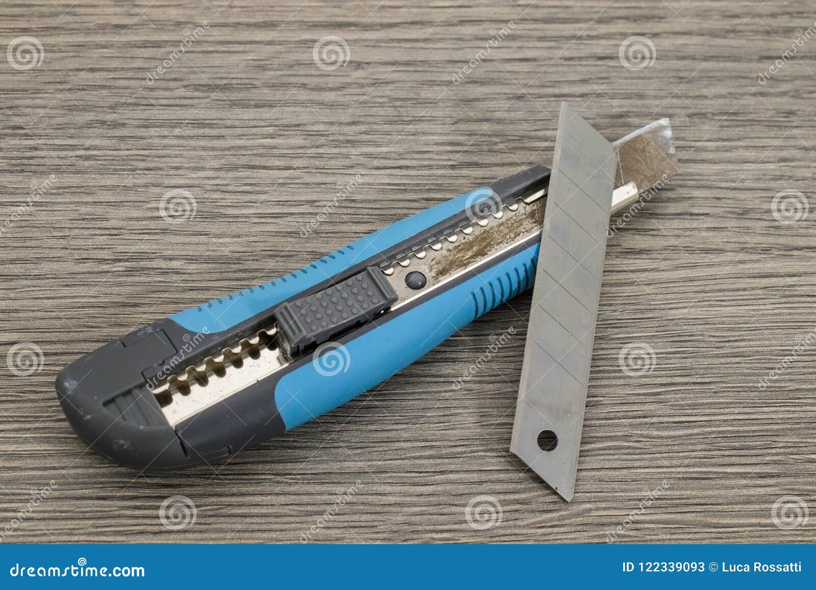 Blue Cutter and Blades on a Decorated Wood Table Stock Image - Image of ...