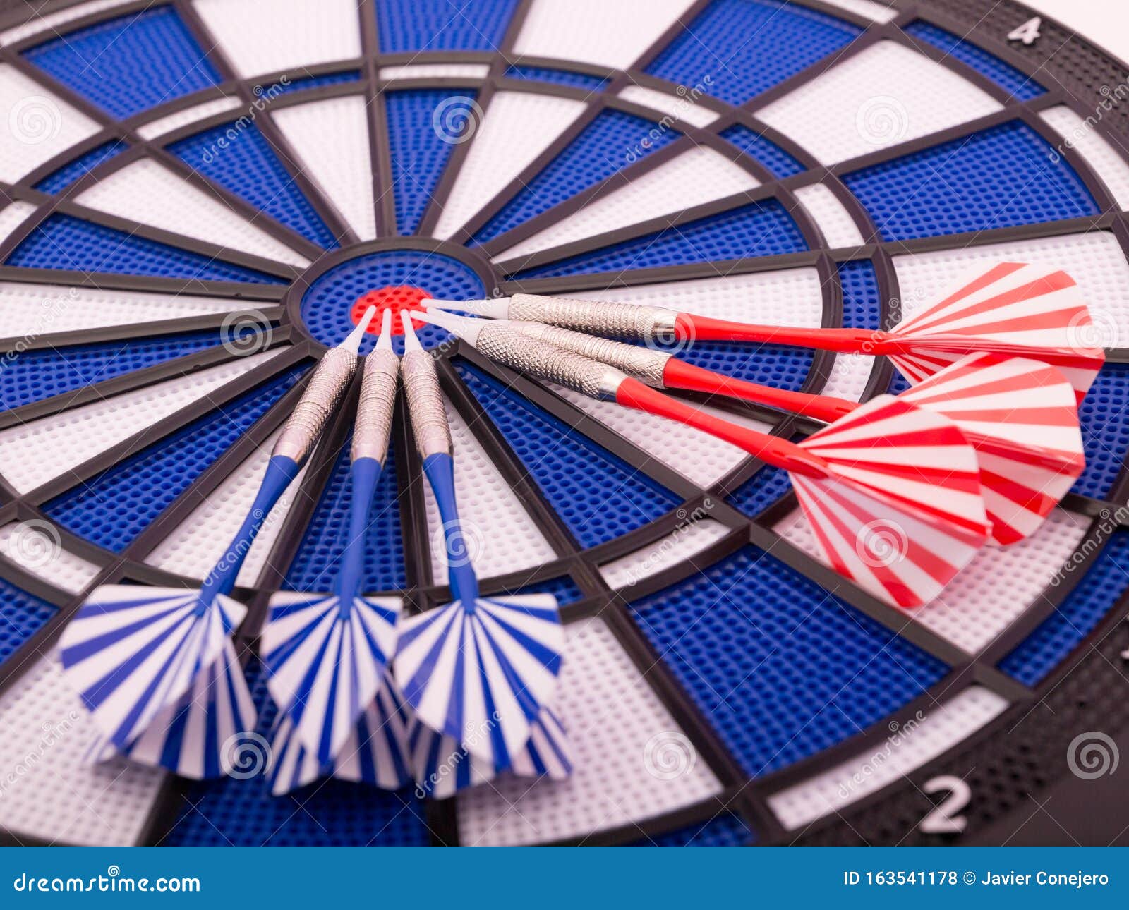 Blue dartboard with darts stock photo. Image of center - 163541178