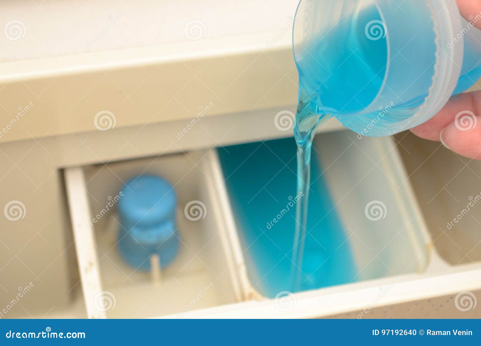A Blue Detergent is Poured into the Washing Container. Stock Photo ...