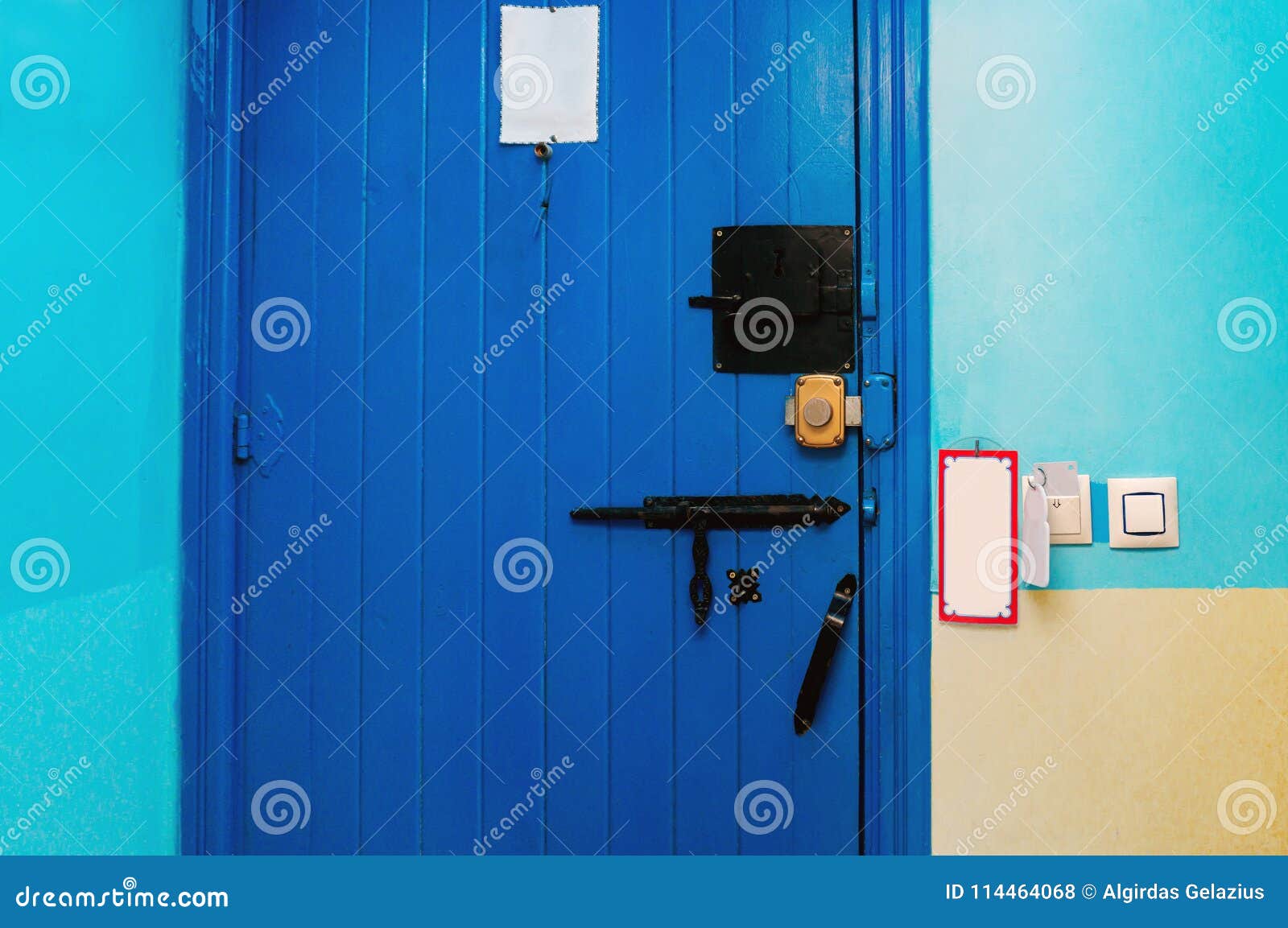 Blue Door with Various Locks and Wall with Cards and Switch in a Stock ...