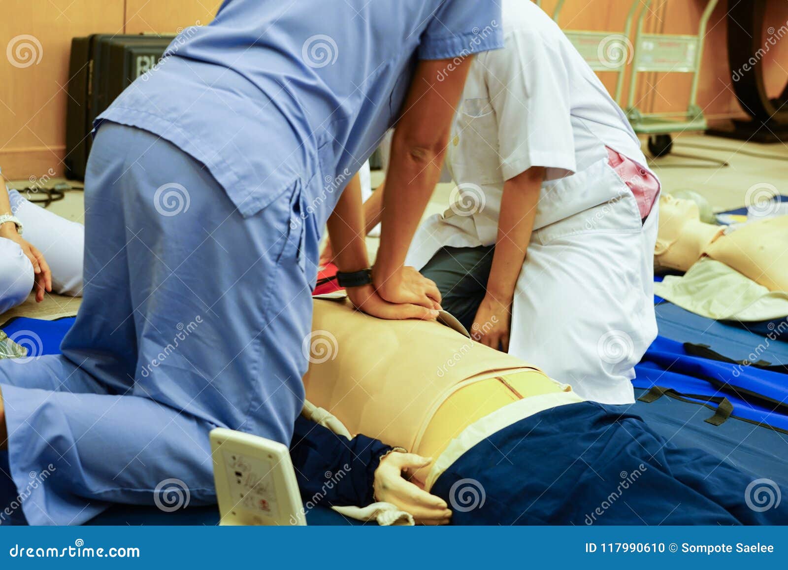 A Blue Dress Trainee Nurse Performing Chest Compression on a Man Stock ...