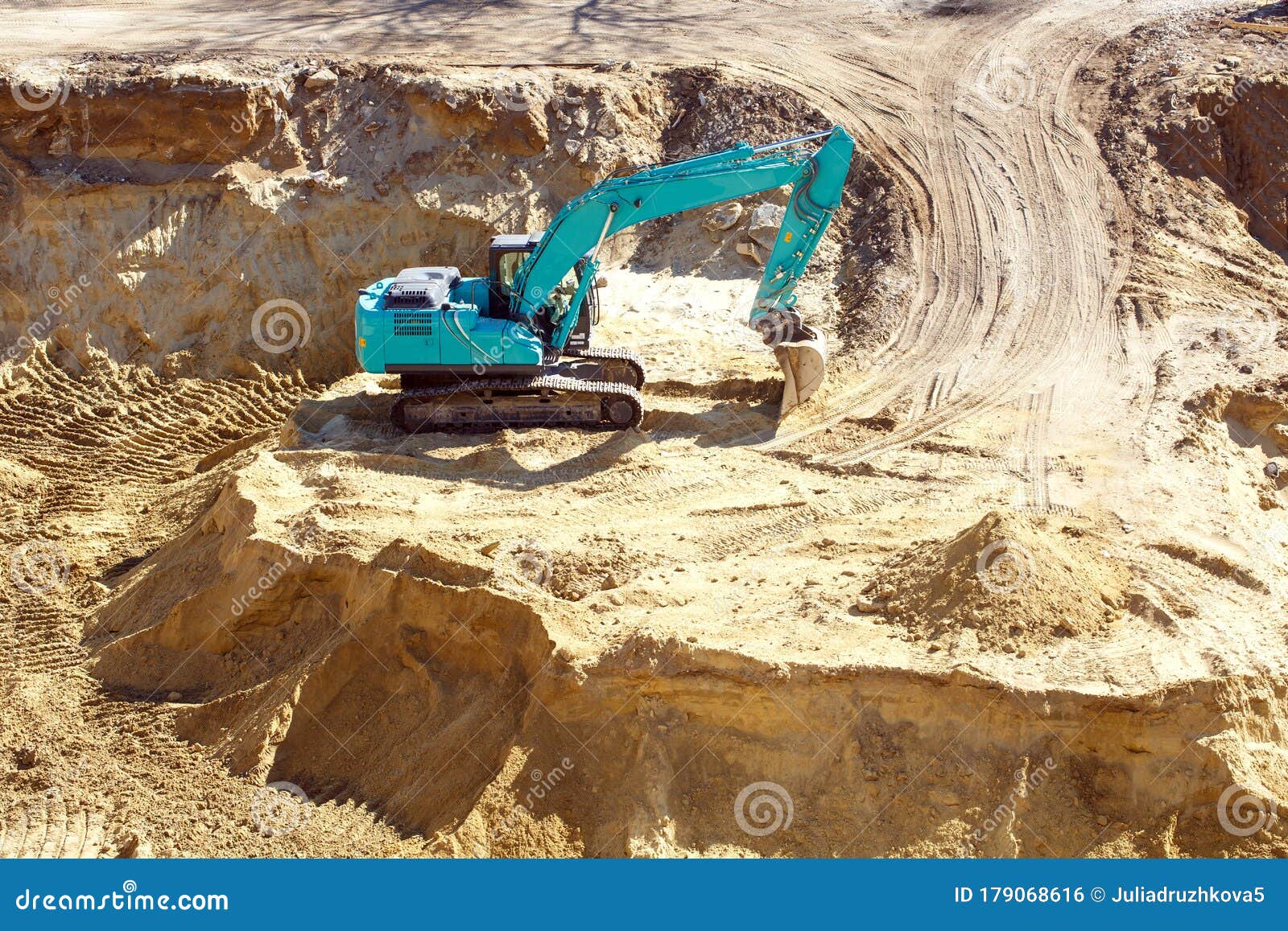 Blue Excavator at a Construction Site Working on a Pile of Sand ...