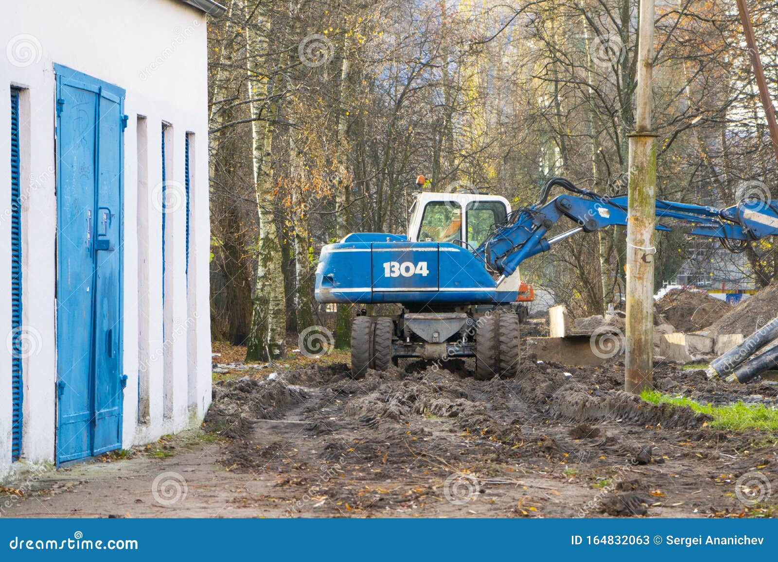 Blue Excavator is Engaged in Excavation Work in the Park Stock Image ...